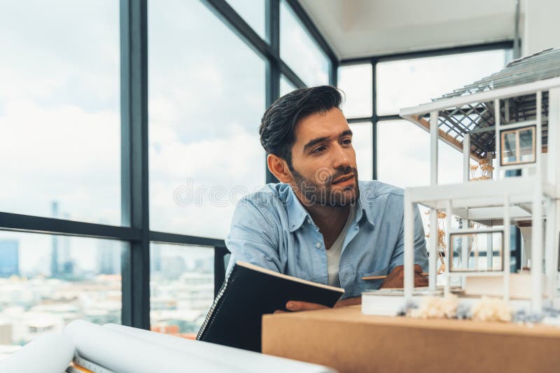 Happy Engineer Inspecting House Model Structure while Holding a Book ...