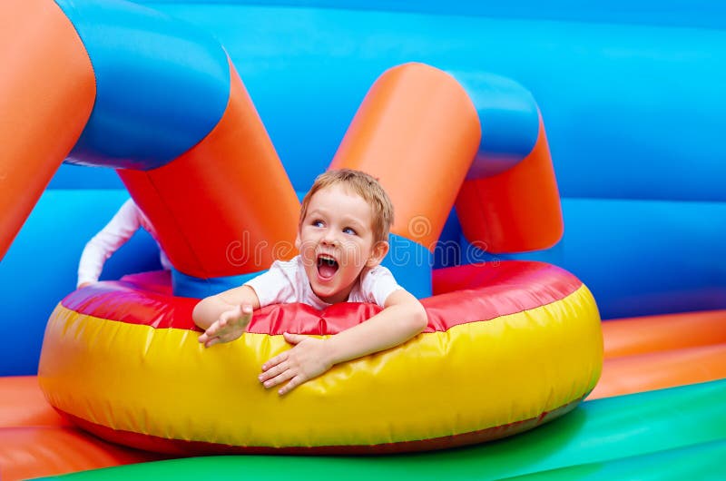 Happy Excited Young Boy Having Fun on Inflatable Attraction Playground ...