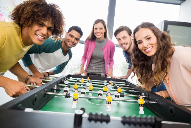 Happy Executives Playing Table Football Stock Photo - Image of ...