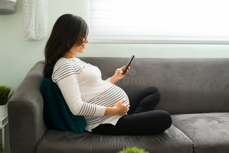 Happy Expectant Mother Sending A Text Message At Home Stock Image Image Of Pregnant Belly