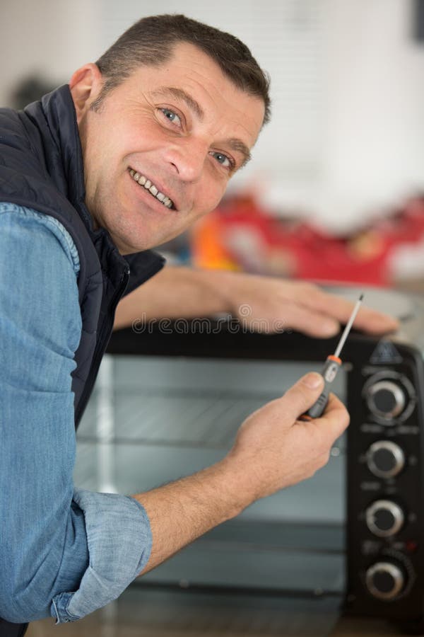 Happy Expert Panel Fixing Kitchen Oven Stock Photo - Image of people ...