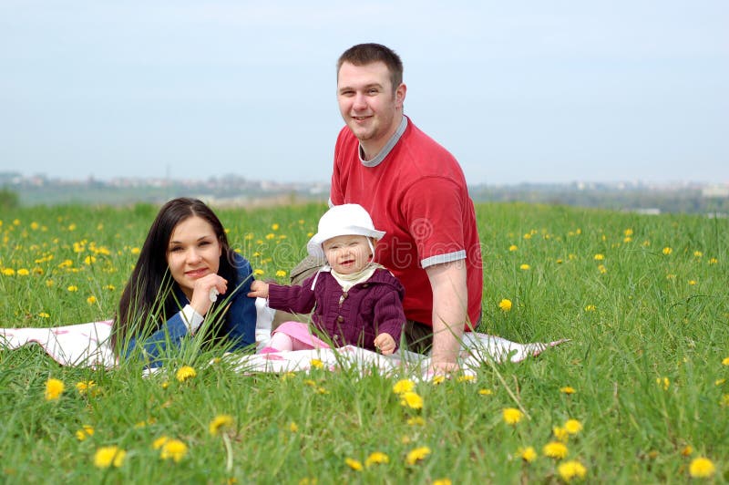 Happy Family Outside in Dandelions Stock Photo - Image of american ...