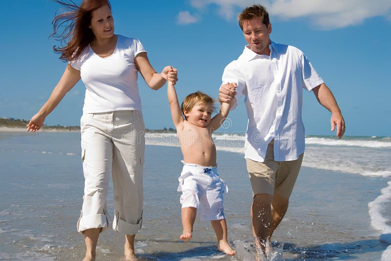 Happy family on a beach stock image. Image of ocean, sand - 2317923