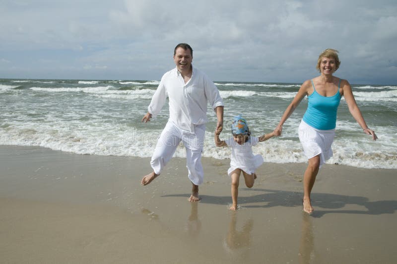 Happy family on the beach stock photo. Image of outdoors - 6332496