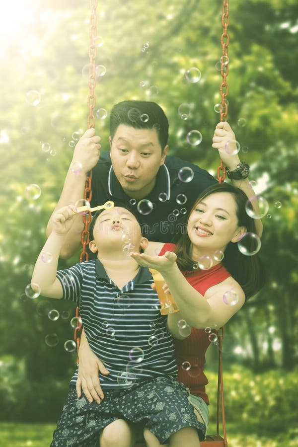 Happy Family Blowing Soap Bubbles in Playground Stock Photo - Image of ... Happy Family Blowing Soap Bubbles in Playground Stock Photo - Image of ...