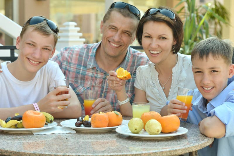 Happy family at breakfast stock photo. Image of attractive - 55675830
