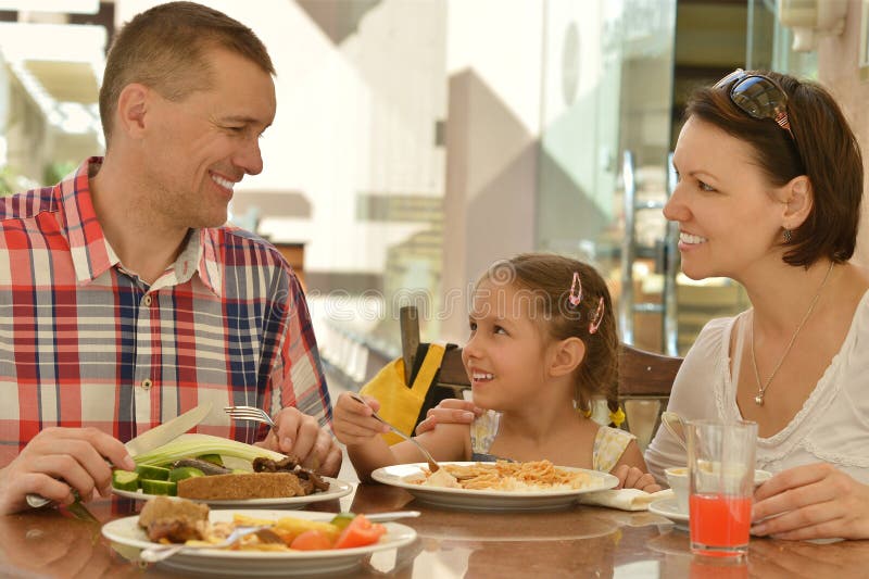 Happy family at breakfast stock photo. Image of girl - 70178512