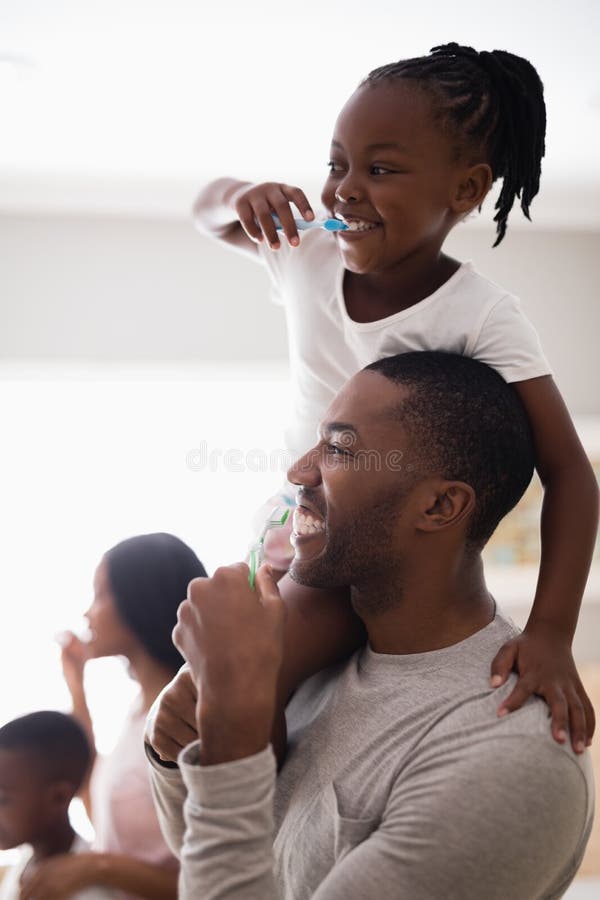 Family Brushing Teeth Together in Bathroom Stock Photo - Image of ...