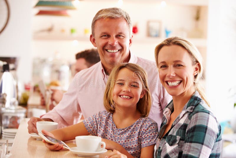 Happy family in a cafe stock photo. Image of daughter - 59769632
