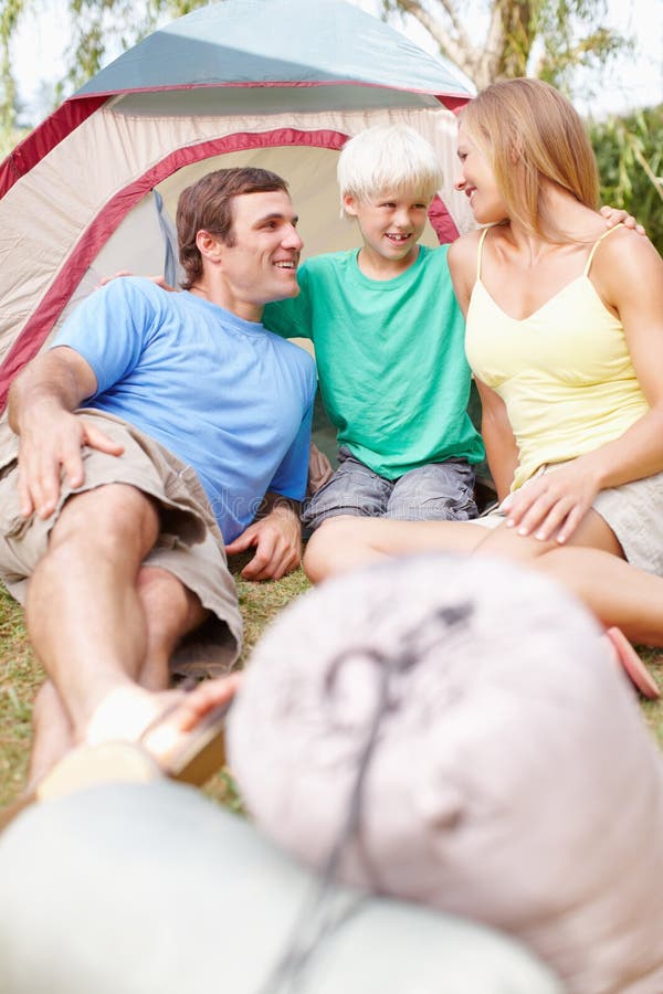 Happy Family Camping. Happy Family of Three Relaxing in Front of Tent ...