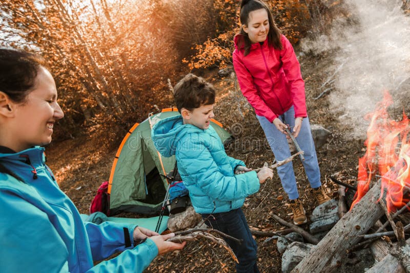 Family on a Camping Trip. Family Doing Camping in the Forest Stock ...