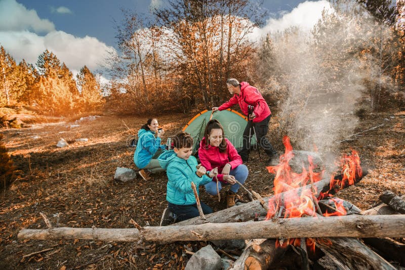 Family on a Camping Trip. Family Doing Camping in the Forest Stock ...