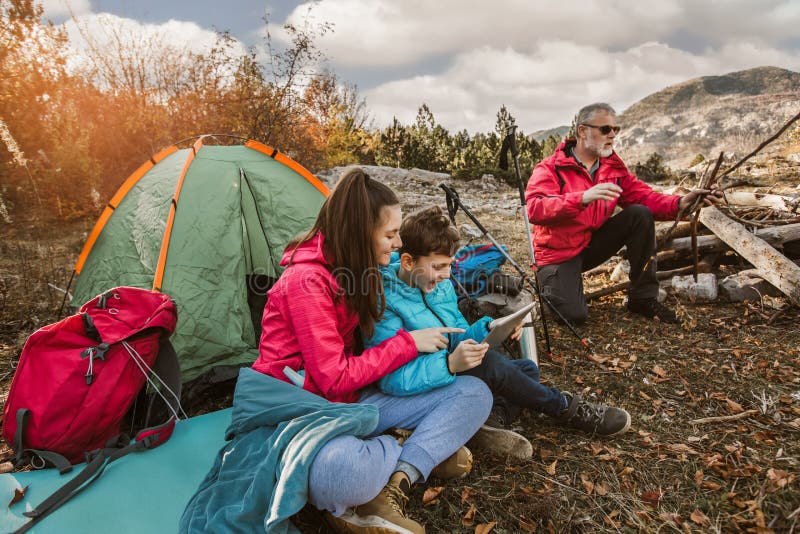 Family on a Camping Trip. Family Doing Camping in the Forest Stock ...