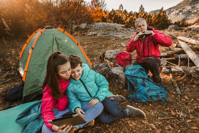 Family on a Camping Trip. Family Doing Camping in the Forest Stock ...