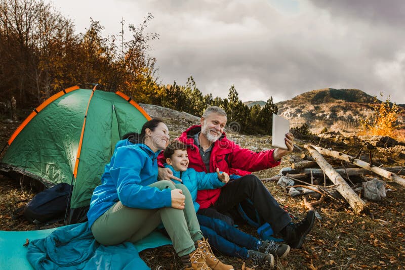 Family on a Camping Trip. Family Doing Camping in the Forest Stock ...