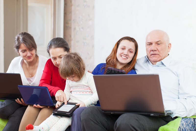 Happy Family with Computers at Home Stock Photo - Image of looks ...