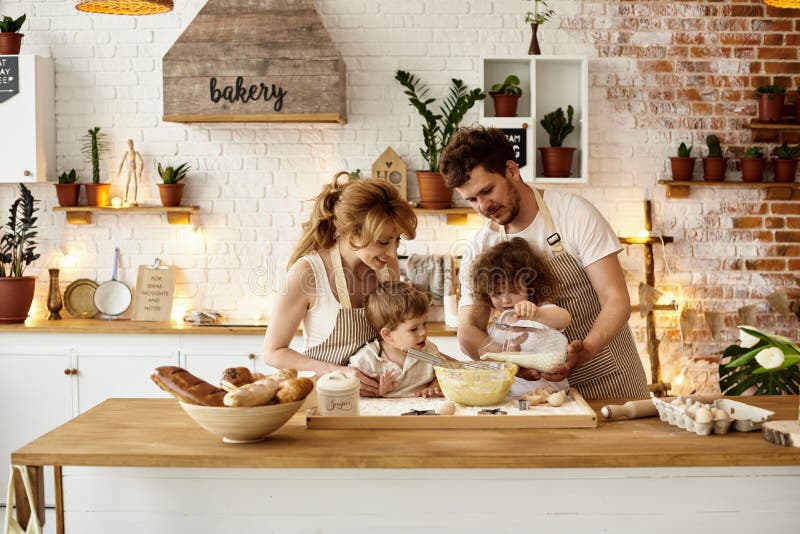 Happy Family with Their Children Cooking in the Kitchen Stock Photo ...