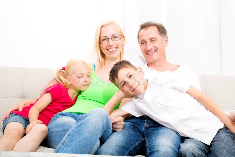 Happy family on the couch stock photo. Image of cute - 44264686