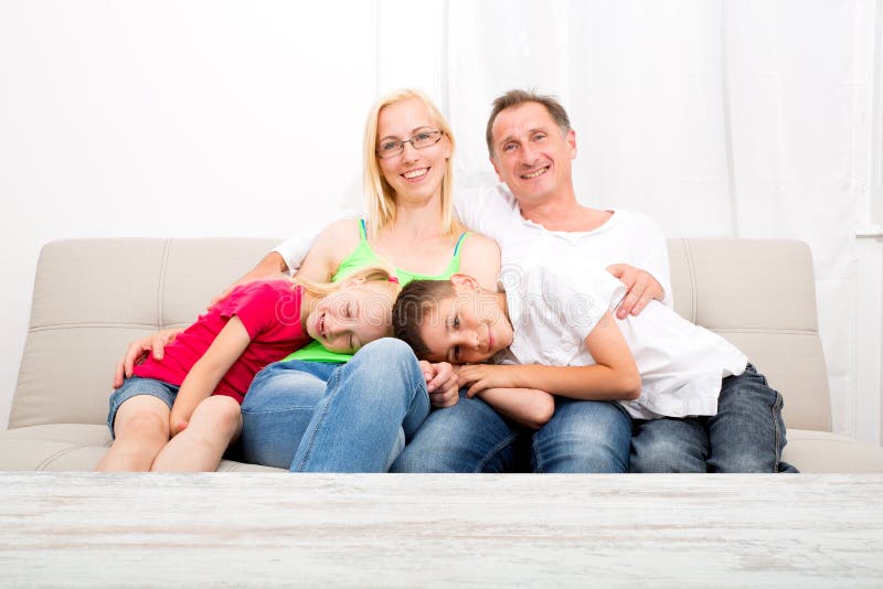 Happy family on the couch stock image. Image of family - 58889507