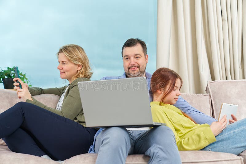 Happy Family on Couch Using Gadget. Rest at Home. Using Digital Devices ...