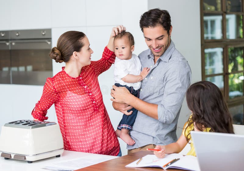 Happy family at desk stock image. Image of children, caucasian - 68200931