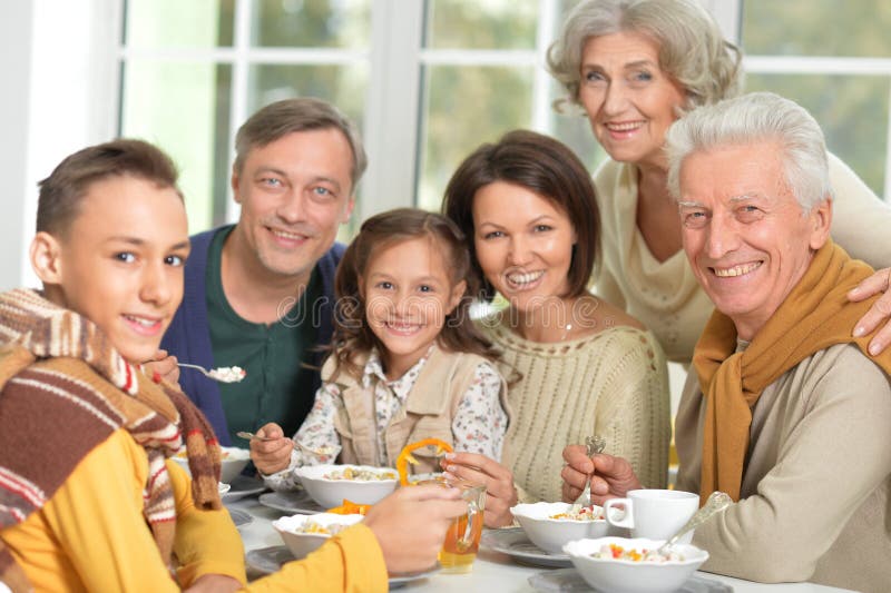 Happy Family of Different Generations Eating Together Stock Photo ...