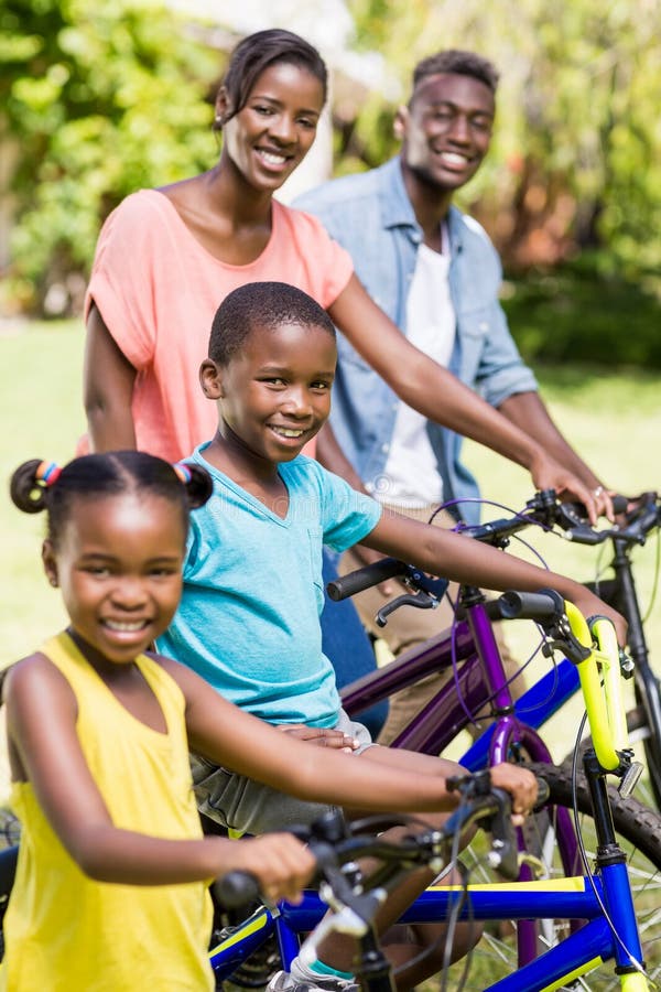 Happy family doing bicycle stock image. Image of entertaining - 69805531