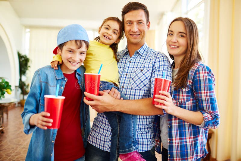 Happy family with drinks stock photo. Image of smiling - 57566424