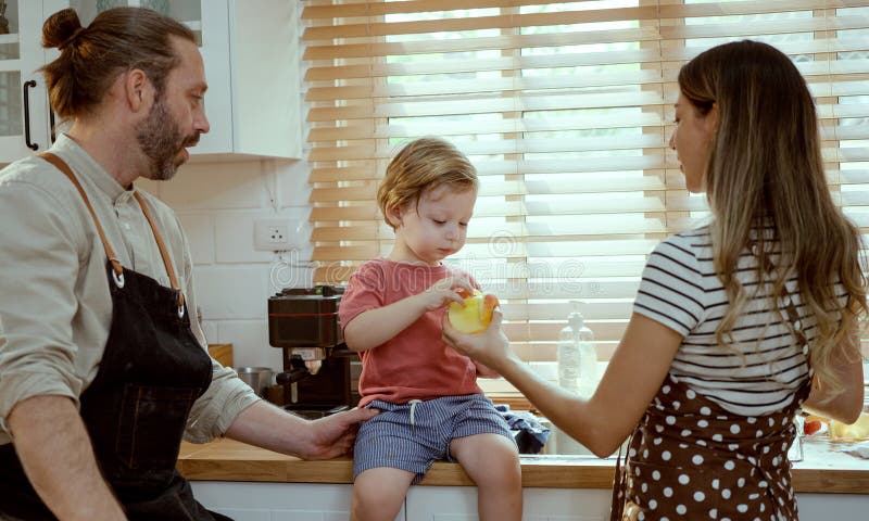 Happy Family Eating Fruits in the Kitchen Stock Photo - Image of ...