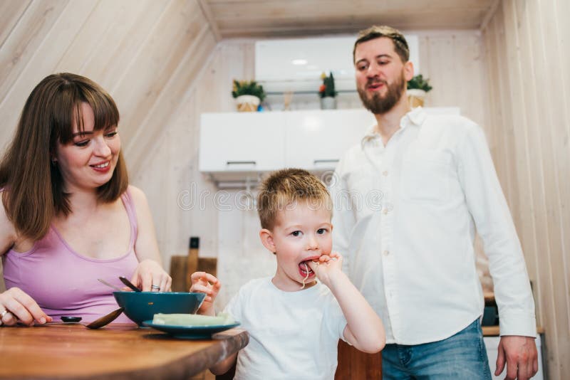 Happy Family Eating Pasta in the Kitchen Stock Image - Image of ...