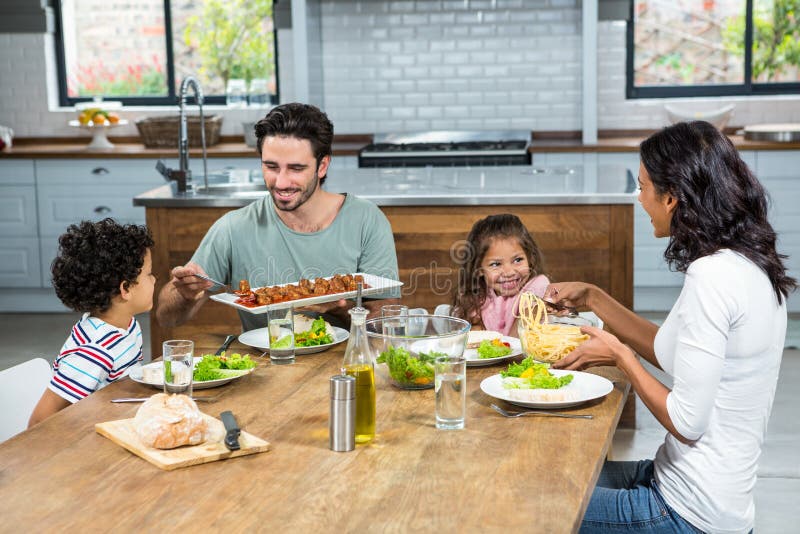 Happy Family Eating Together in the Kitchen Stock Photo - Image of ...