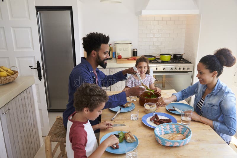 Happy Family Eating Together at Their Kitchen Table Stock Image - Image ...