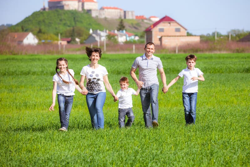 Happy family in a field stock photo. Image of jeans, nature - 43342076