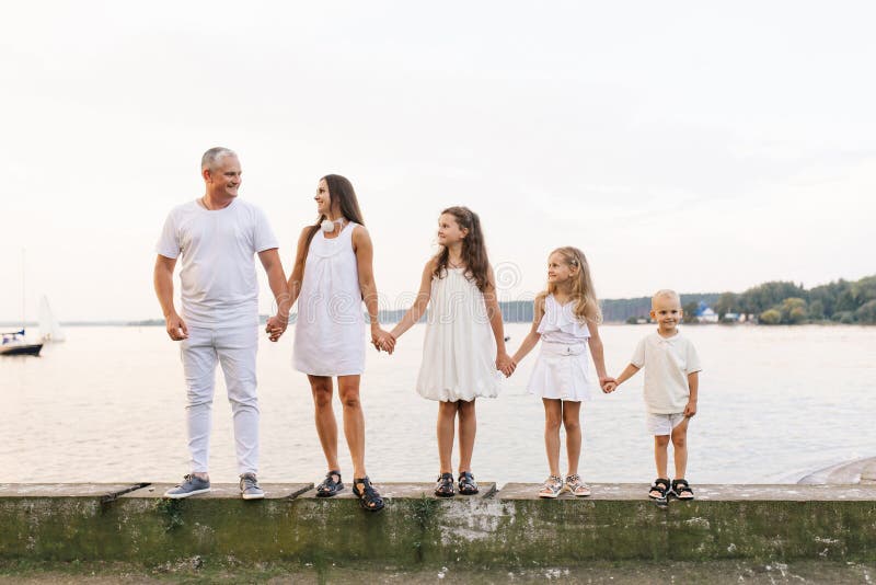 Happy Family of Five is Standing on Pier by the Water Stock Photo ...