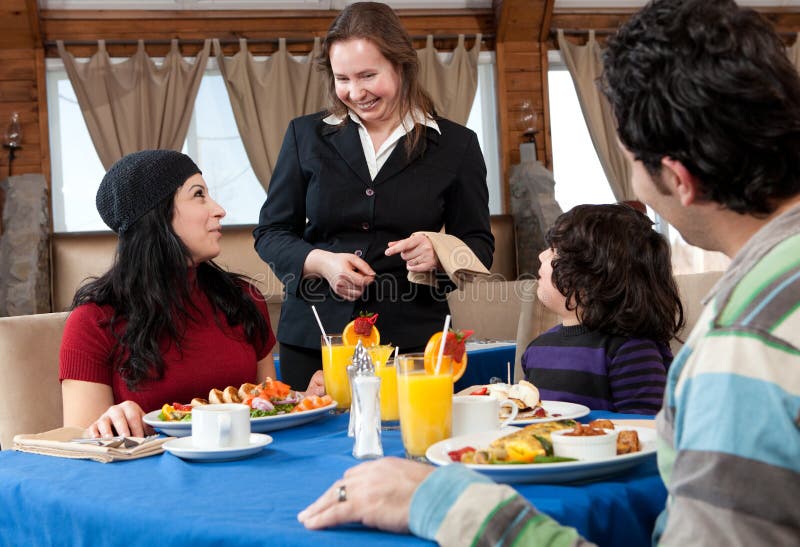 Happy Family Having Breakfast at a Restaurant Stock Photo - Image of ...