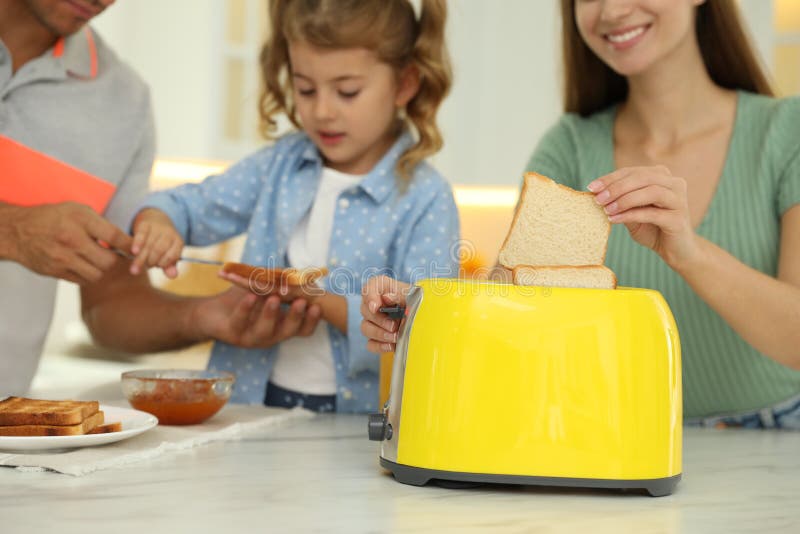 Happy Family Having Breakfast with Toasted Bread at Table in Kitchen ...