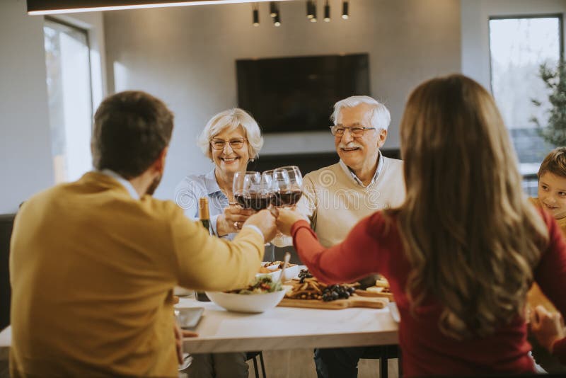 Happy Family Having Dinner with Red Wine at Home Stock Photo - Image of ...
