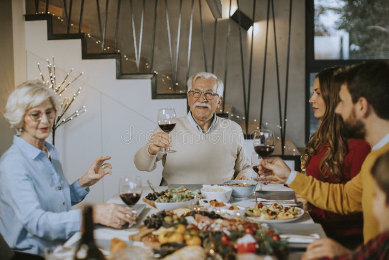 Happy Family Having Dinner with Red Wine at Home Stock Photo - Image of ...