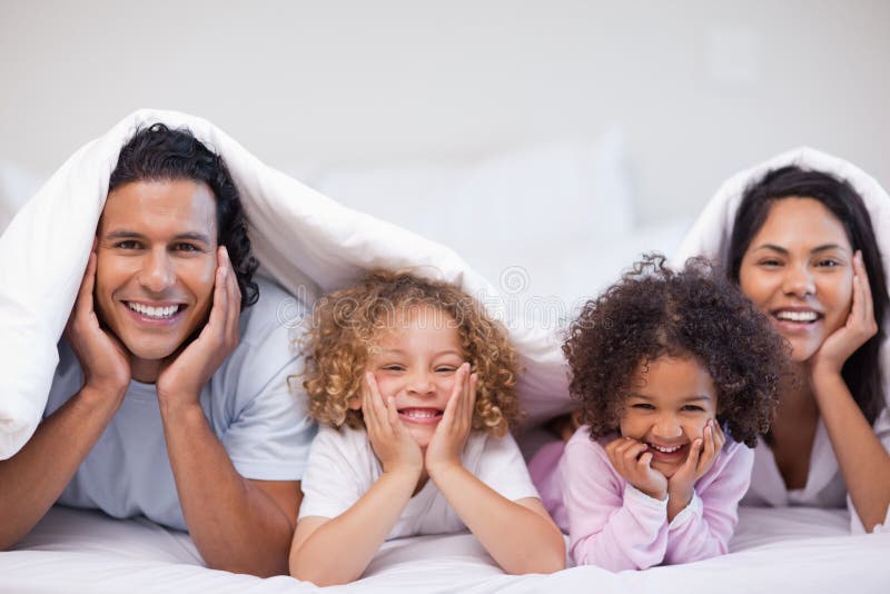Happy Family Hiding Under the Blanket Stock Photo - Image of adult ...