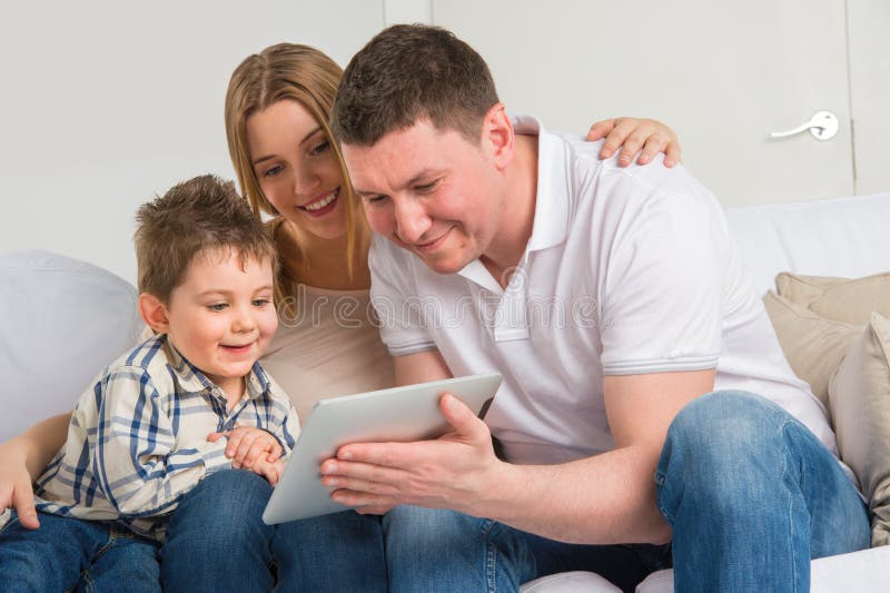 Happy Family at Home Using Electronic Tablet Stock Photo - Image of ...