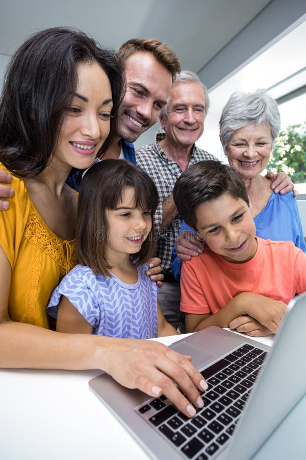 Happy Family Interacting Using Laptop Stock Photo - Image of generation ...