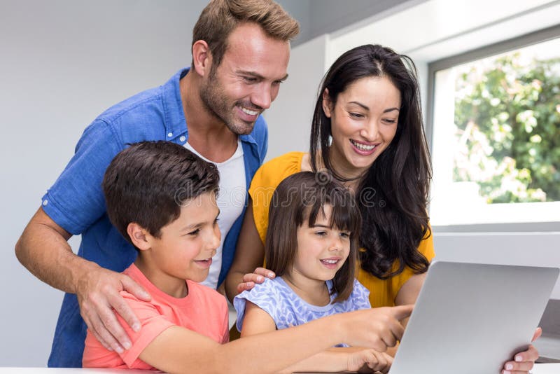 Happy Family Interacting Using Laptop Stock Image - Image of four ...