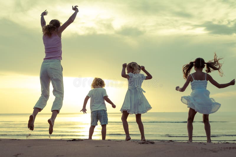 Happy Family Jumping on the Beach Stock Photo - Image of happiness ...