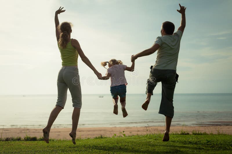 Happy Family Jumping on the Beach Stock Photo - Image of silhouette ...