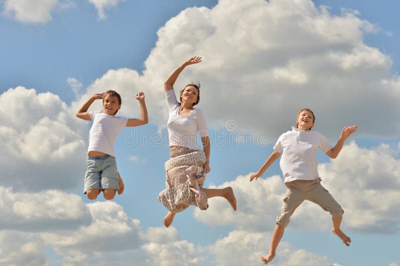 Happy family jumping stock image. Image of leisure, together - 44062037