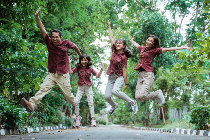 Happy Family Jumping with Raised Hands Stock Photo - Image of activity ...