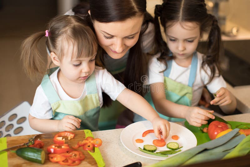 Happy Family in the Kitchen. Mom and Daughters Playing and Having Fun ...