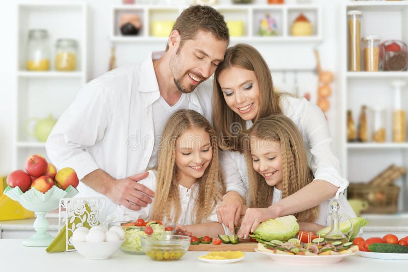 Happy family at kitchen stock photo. Image of friends - 72441252