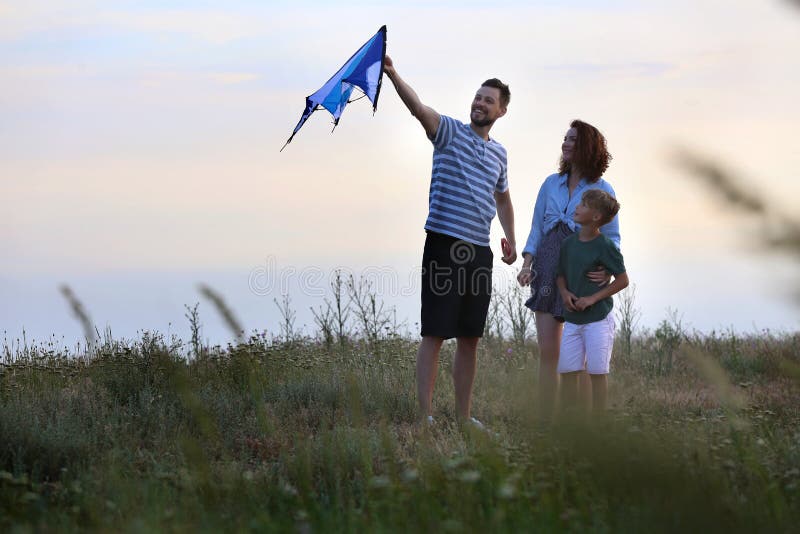 Happy Family with Kite Outdoors Stock Photo - Image of grass, bonding ...