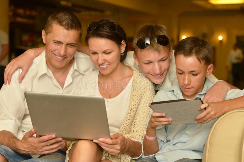 Happy family with laptop stock photo. Image of natural - 77969862